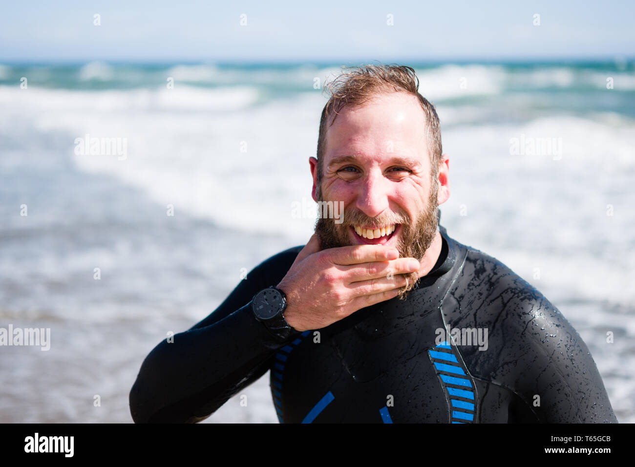 Triathlon man in wetsuit on the beach Stock Photo - Alamy