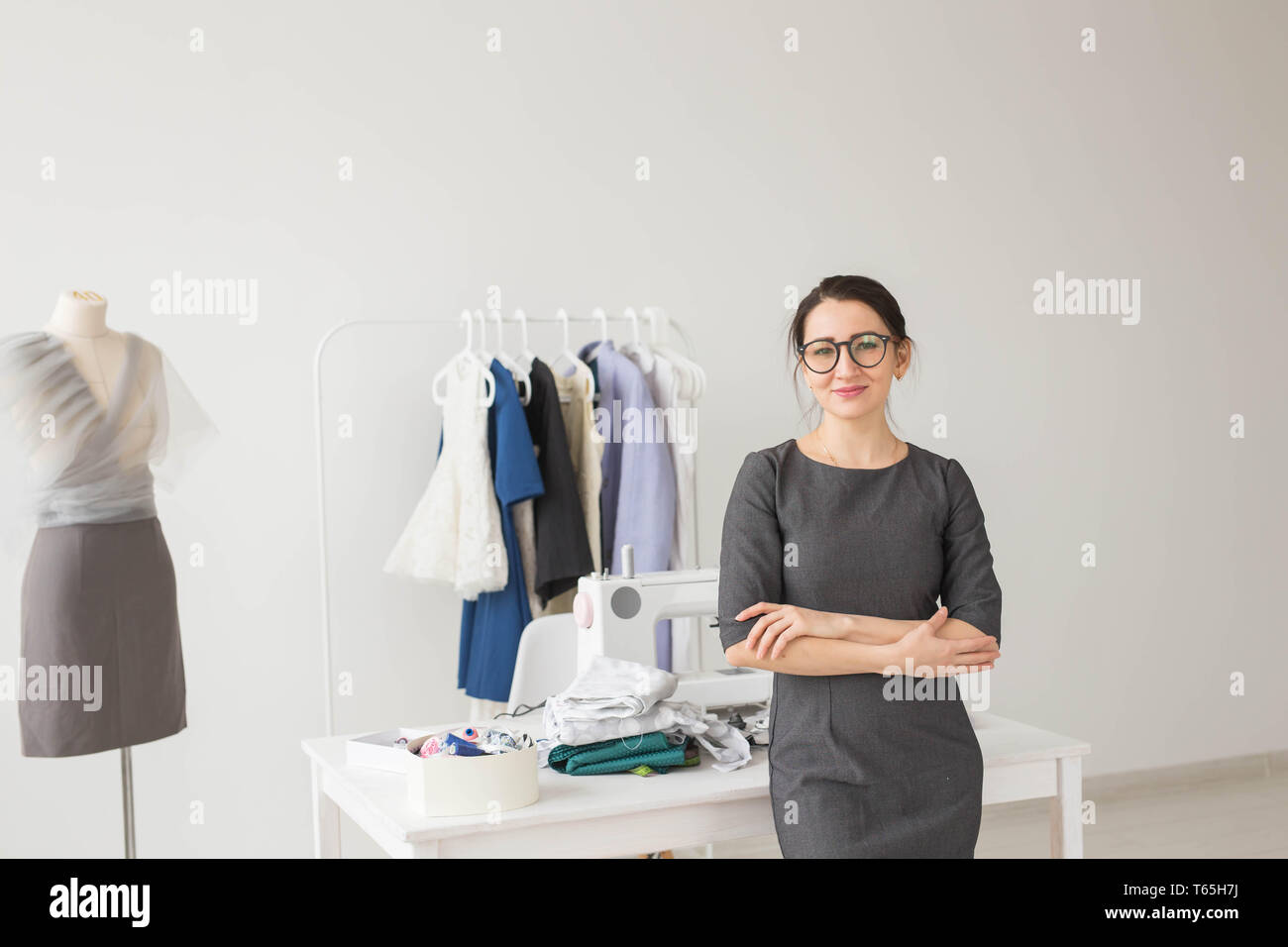 Dressmaker, fashion designer and tailor concept - Young dressmaker ...