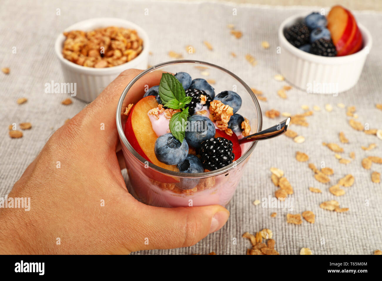Close up portion of muesli granola breakfast with yogurt, fruits and ...