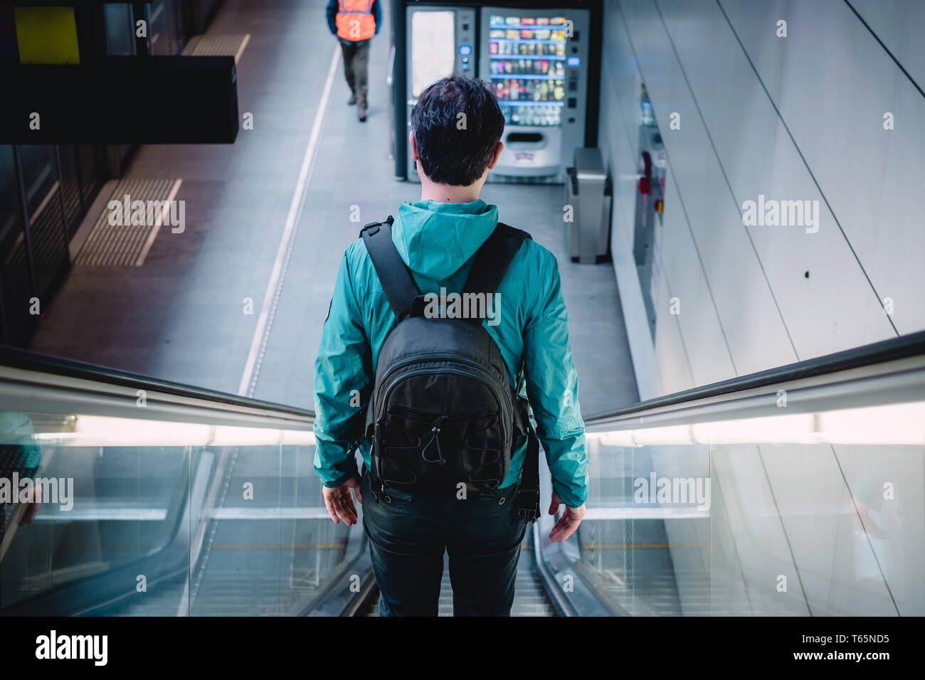 Back view of young man traveling in underground metro station Stock ...