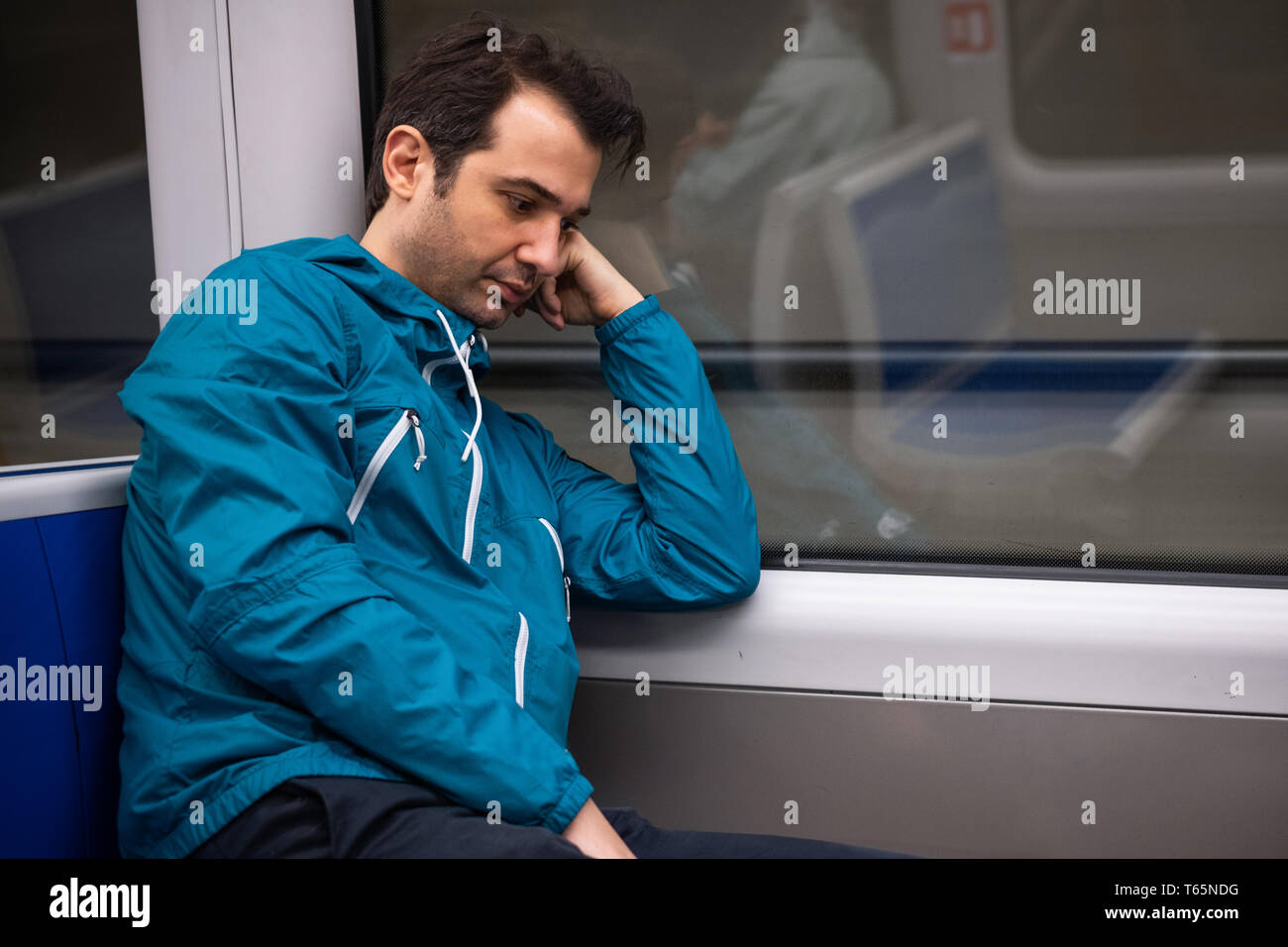 Sad young man in train hi-res stock photography and images - Alamy