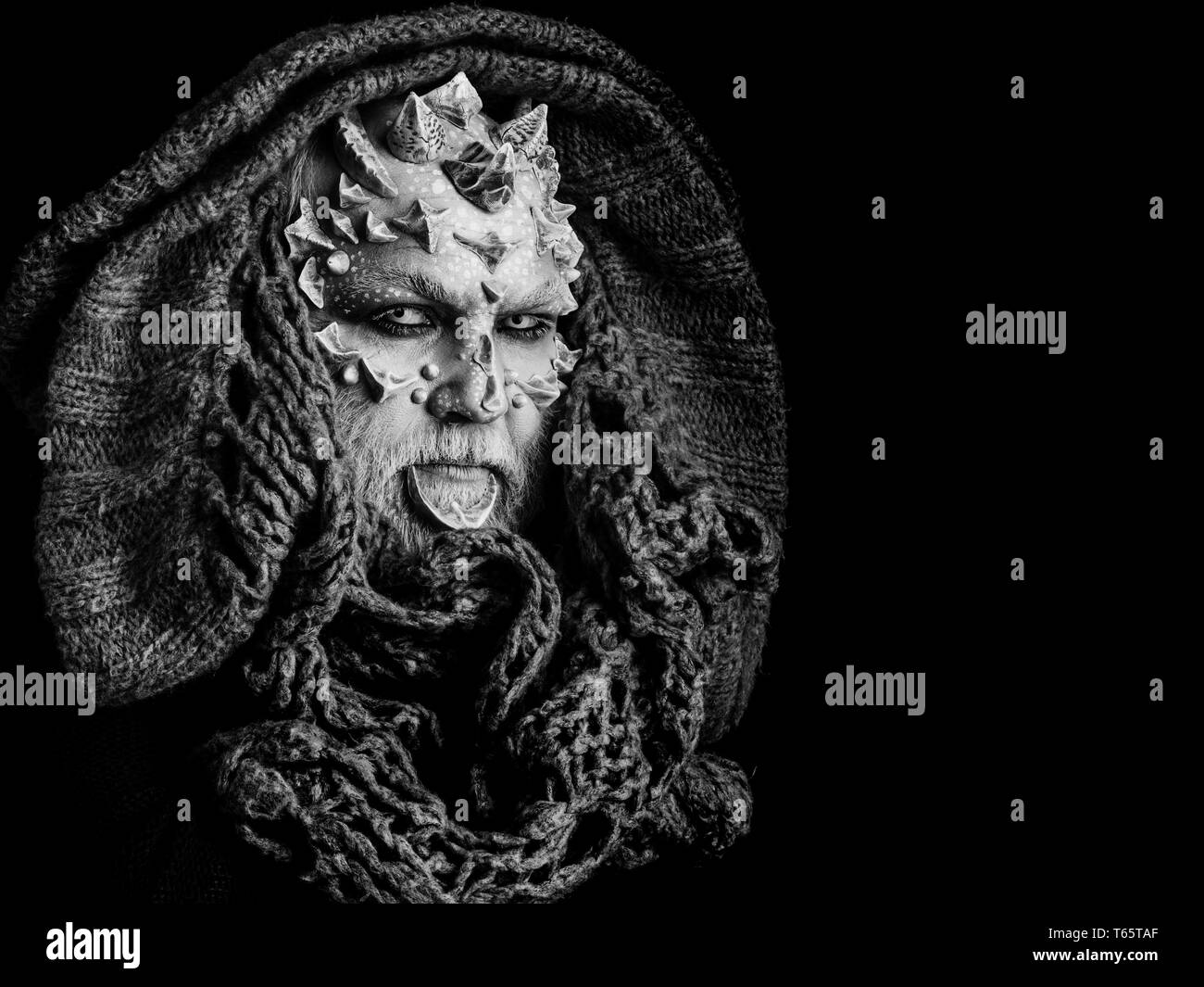 Monster face with white eyes, thorns and warts Stock Photo - Alamy