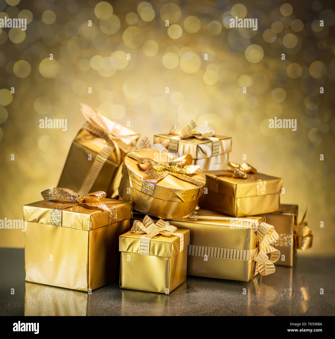 Golden gift boxes as a symbol of wishes and celebration. Golden blurred ...