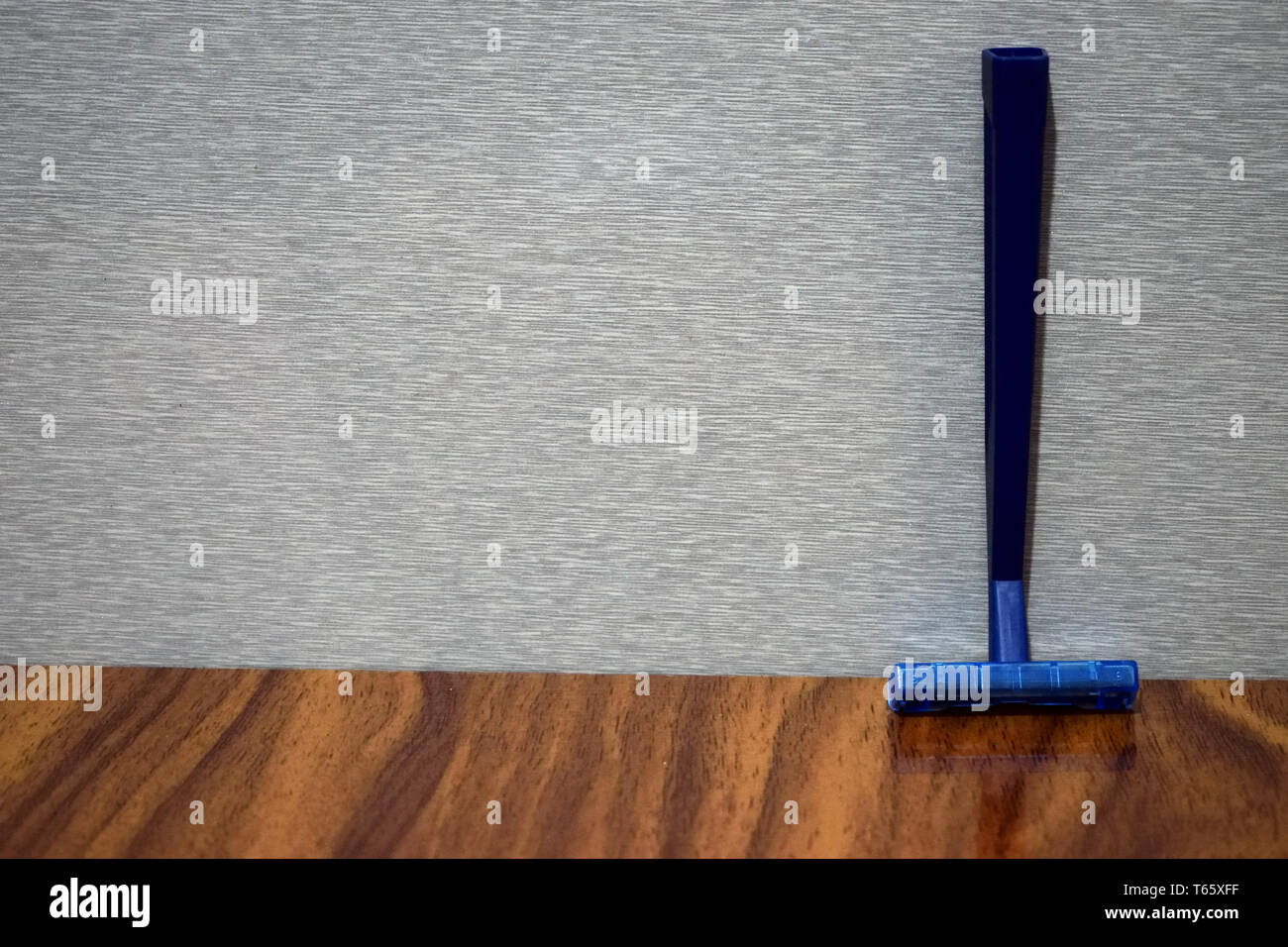 wet shave razor on a wooden table with grey background Stock Photo - Alamy