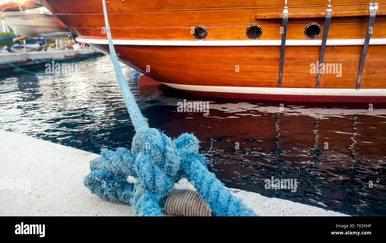 Closeup image of old big rope mooring historic wooden ship at port ...