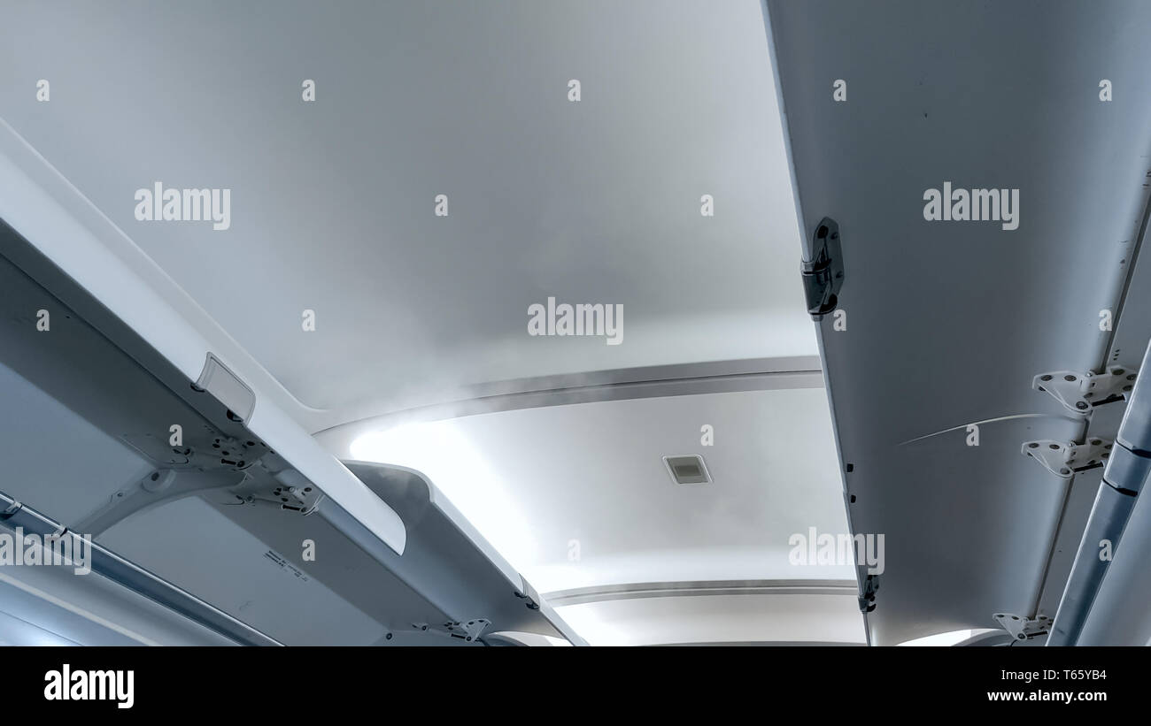 Open luggage storage area under the ceiling at airplane Stock Photo - Alamy
