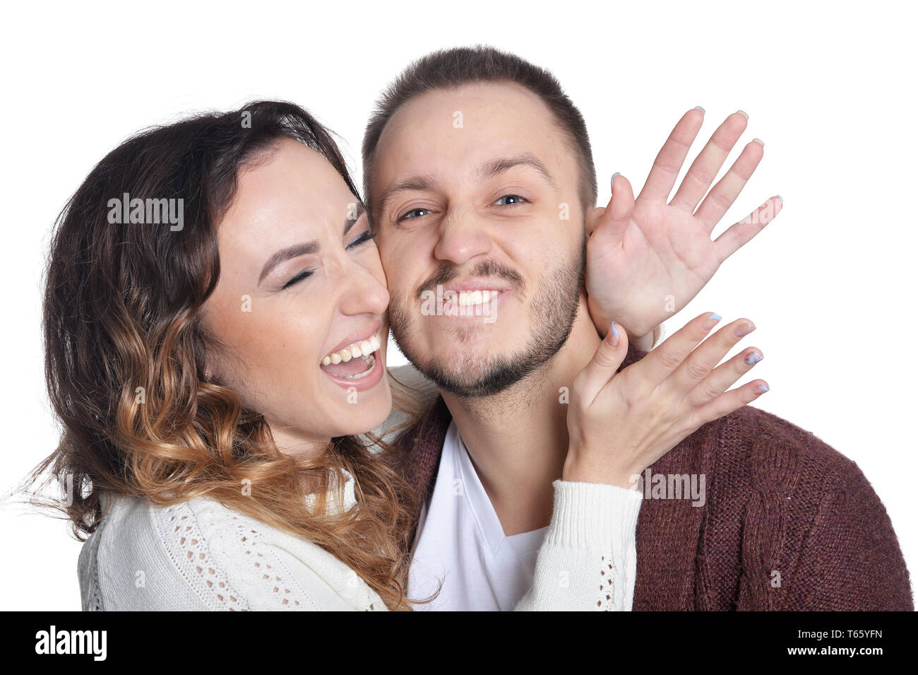 Portrait of happy young couple hugging on white background Stock Photo ...