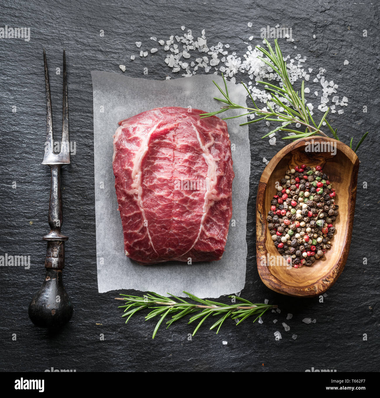 The top blade steak or beef steak on the graphite board with herbs and ...