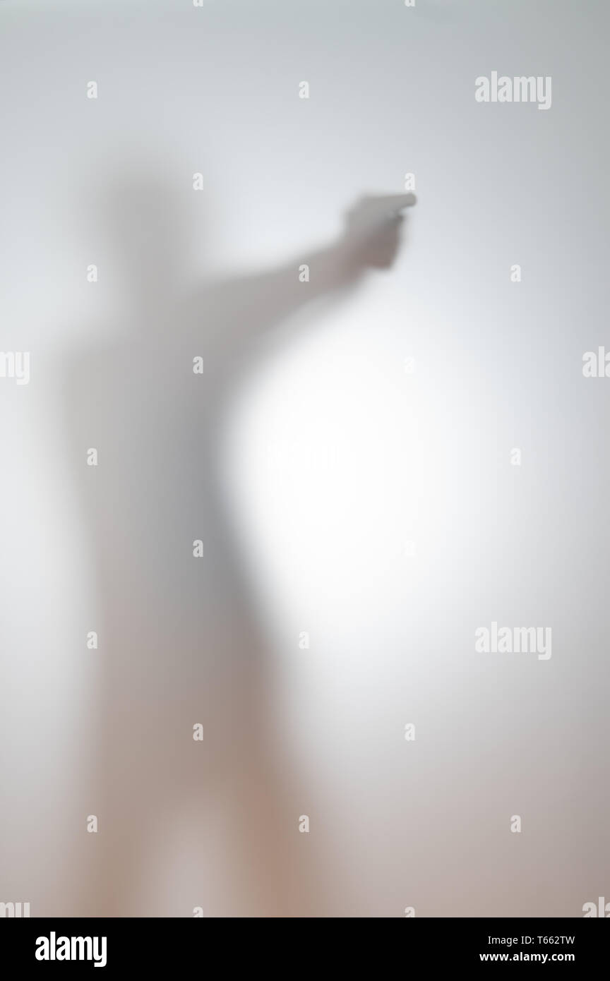 blurred silhouette of a man with a gun Stock Photo - Alamy