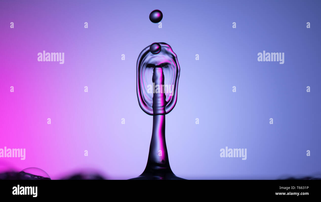 Close-up of a water drop falling on water surface Stock Photo - Alamy