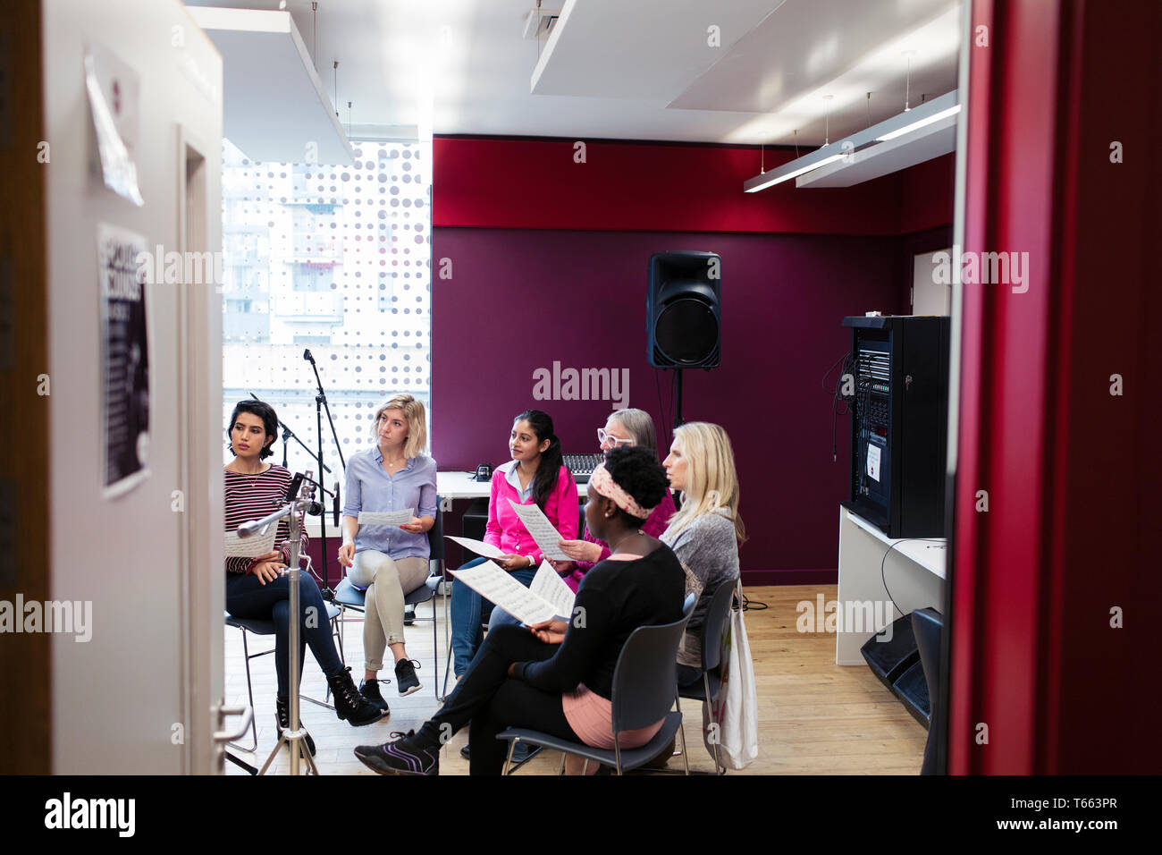 Womens choir with sheet music singing in music recording studio Stock ...