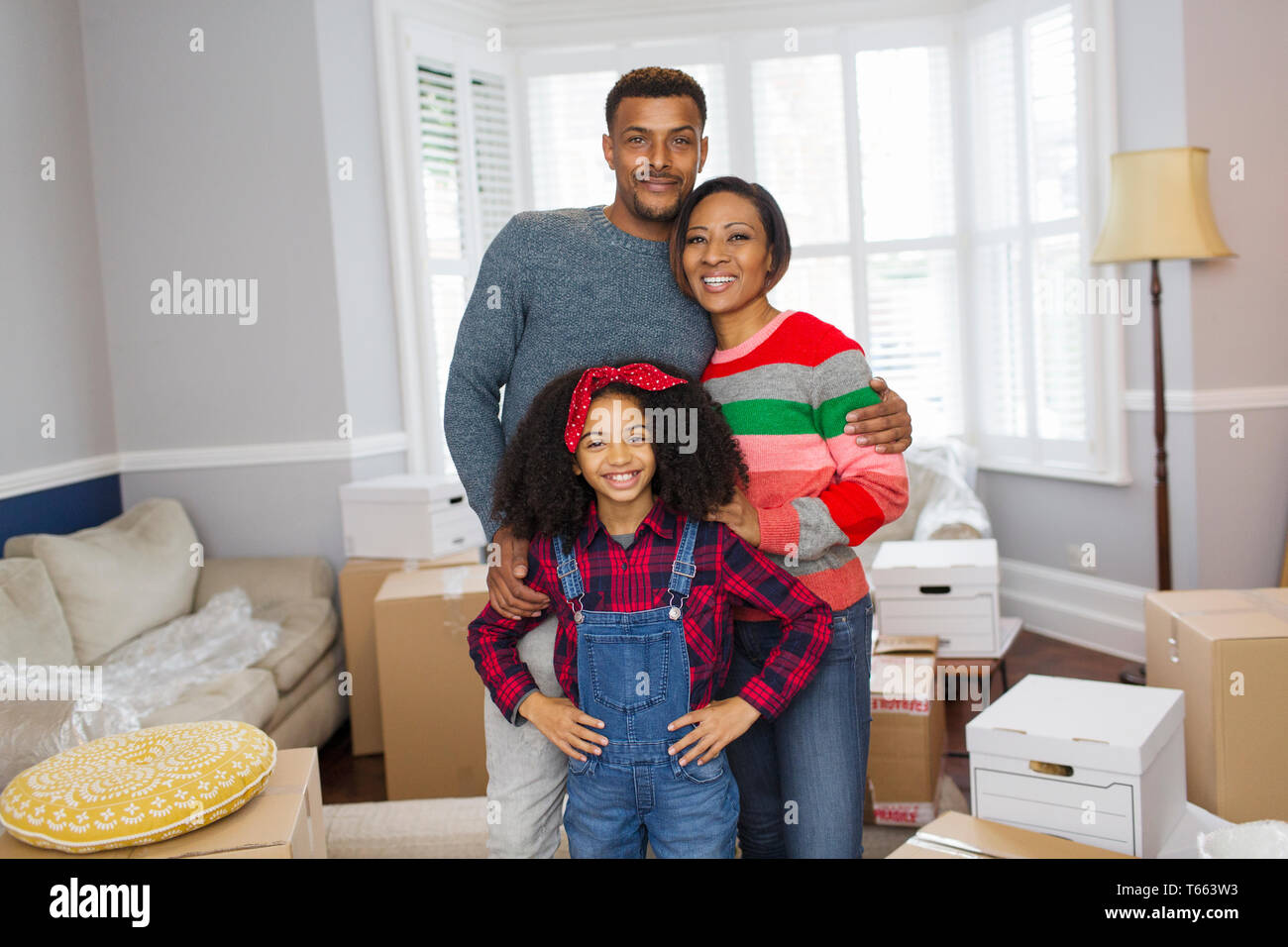 Portrait happy family moving house Stock Photo - Alamy