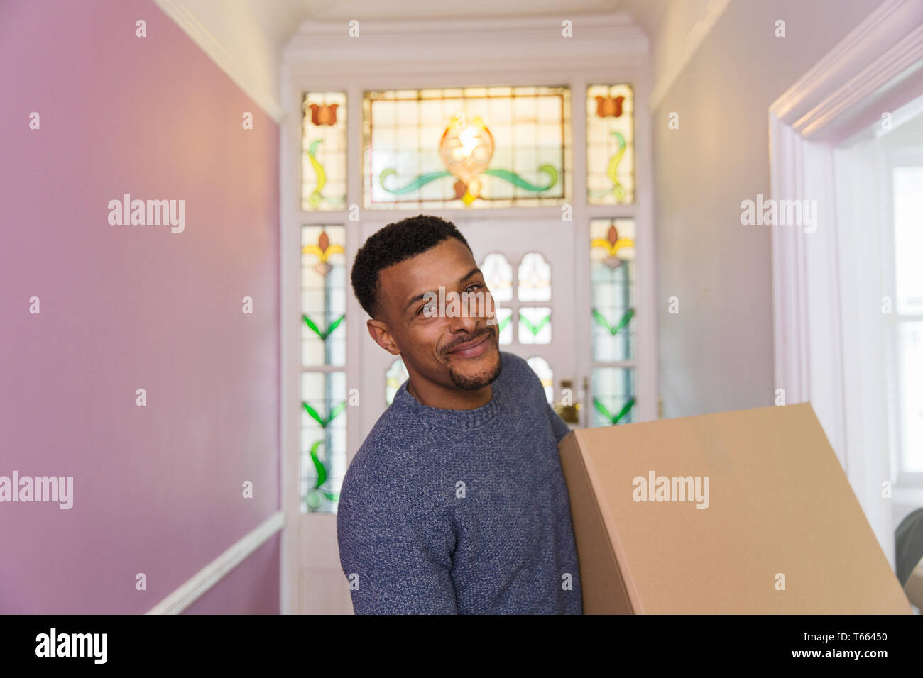 Portrait smiling, confident man moving into new house Stock Photo - Alamy