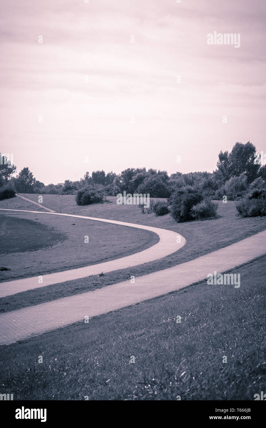 vintage style landscape with curved way's Stock Photo - Alamy