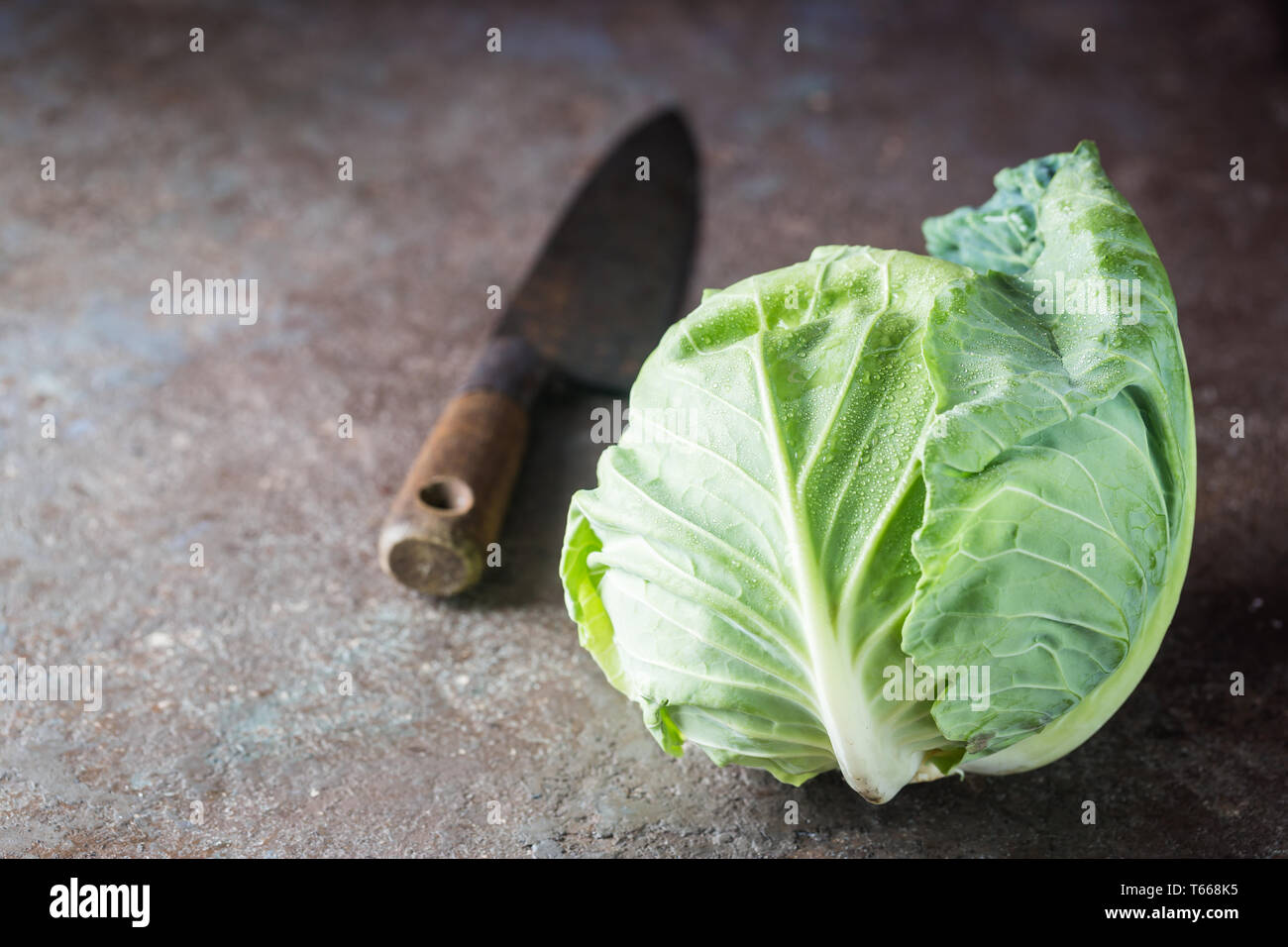 Fresh green garden cabbage on rustic stone background Stock Photo - Alamy