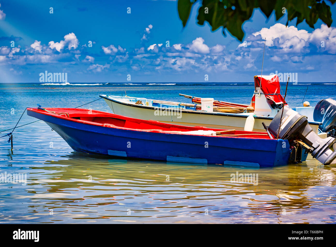 Small wooden colorful boat on crystal blue water ocean at gold time ...
