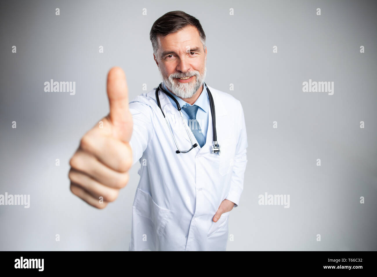 Happy smiling doctor with thumbs up gesture, isolated on white ...