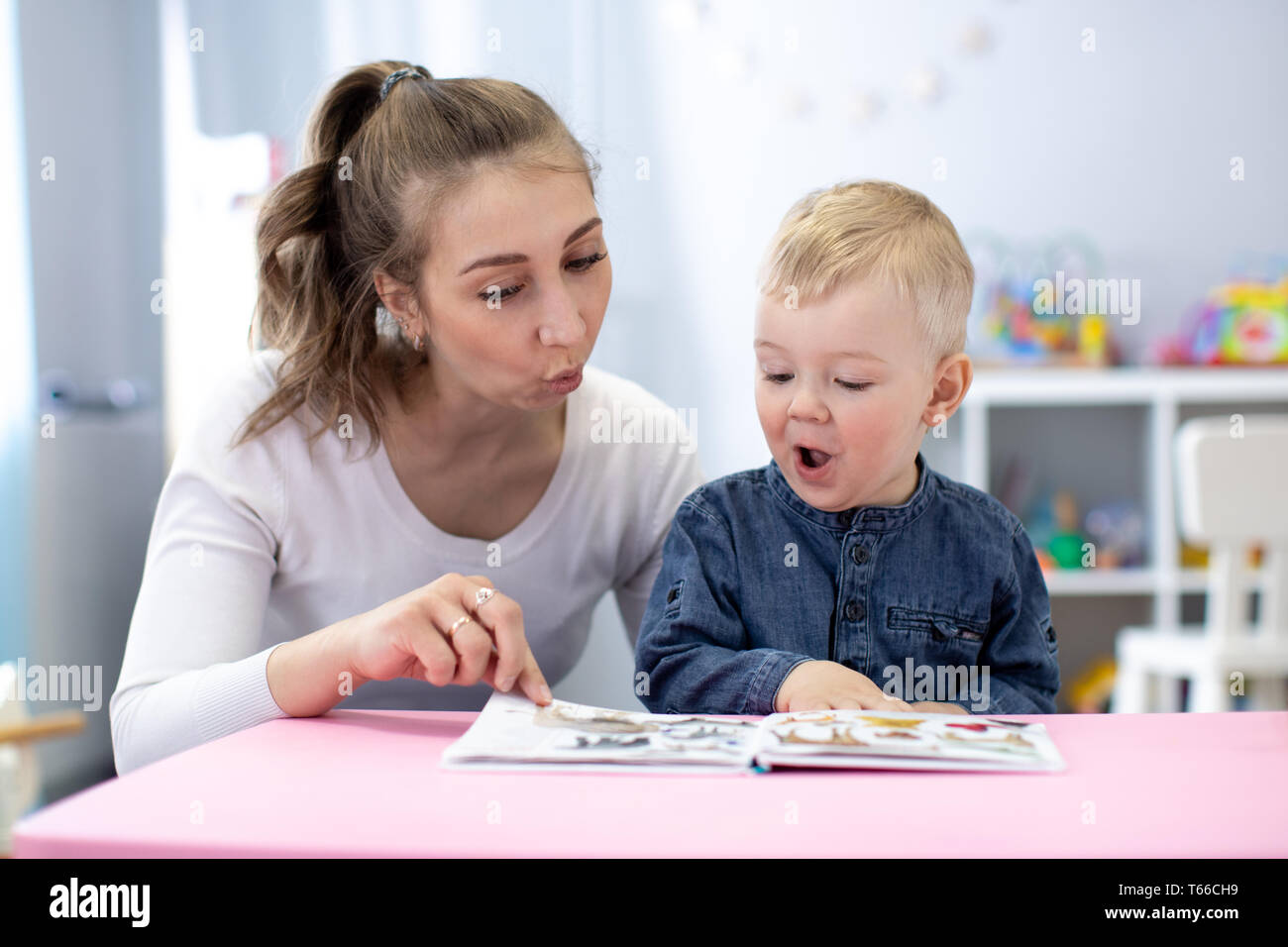 Speech therapist teaching letter pronunciation to child boy in ...