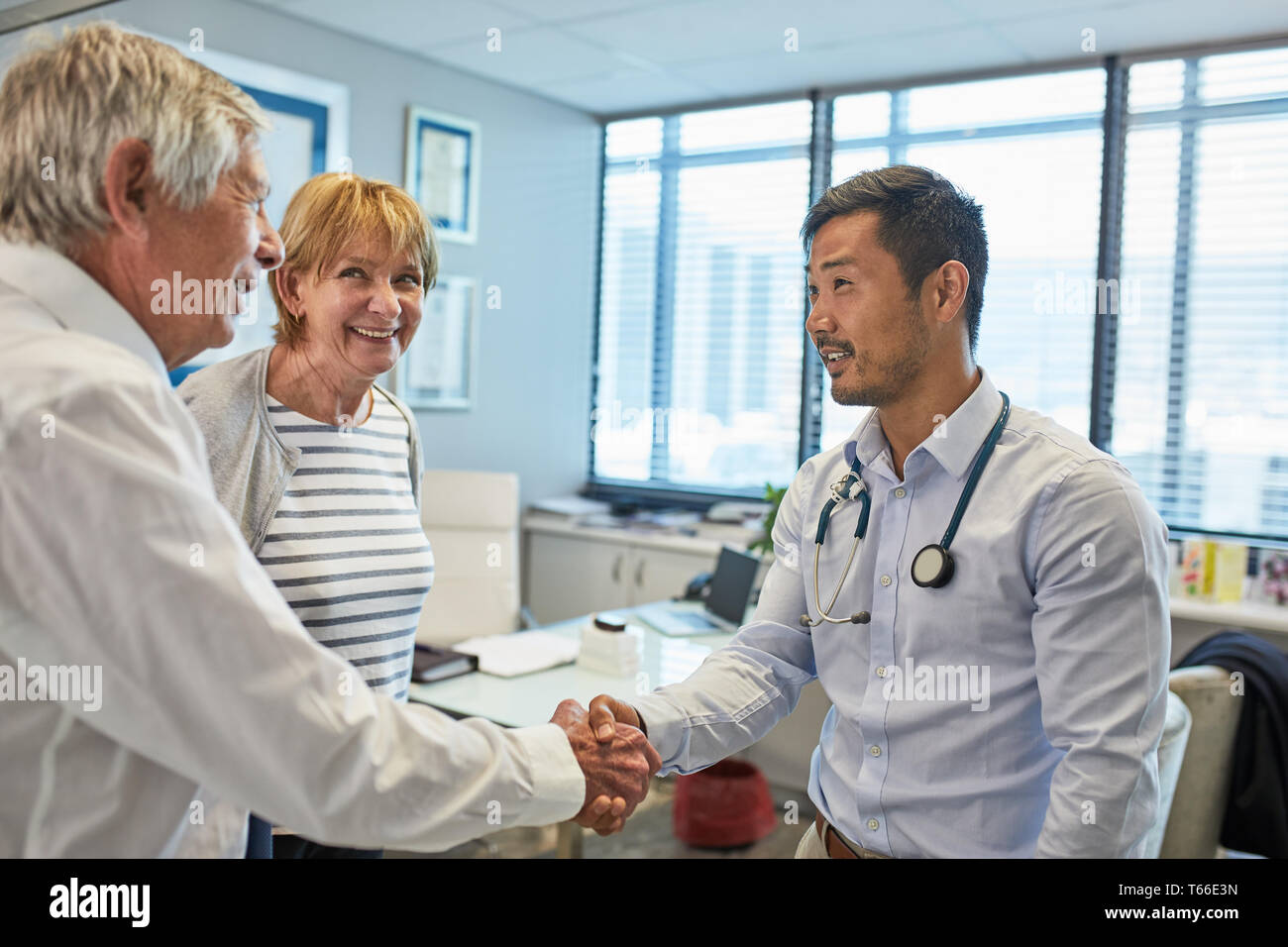 Asian patient doctor handshake hi-res stock photography and images - Alamy
