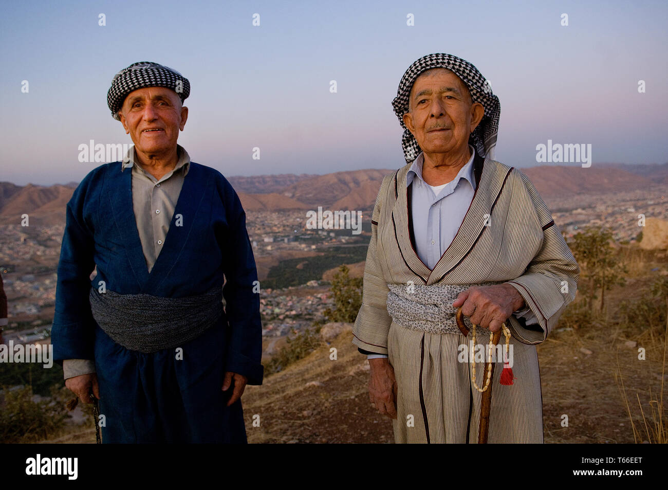 Kurdish men wearing traditional clothes take in the view of Dohuk ...