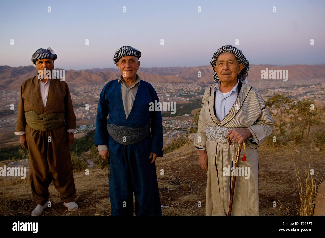 Kurdish men wearing traditional clothes take in the view of Dohuk ...