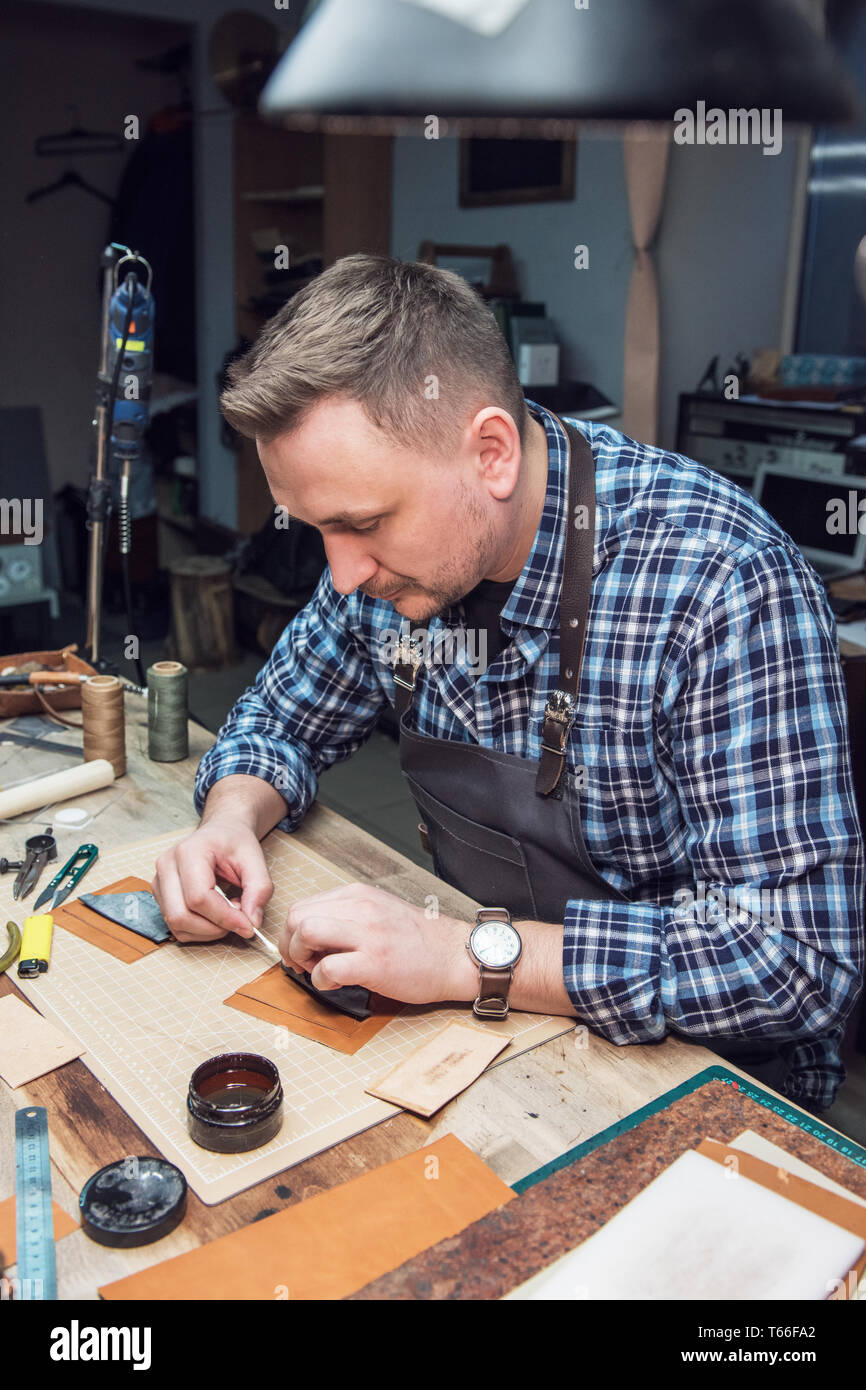 Concept of handmade craft production of leather goods Stock Photo - Alamy