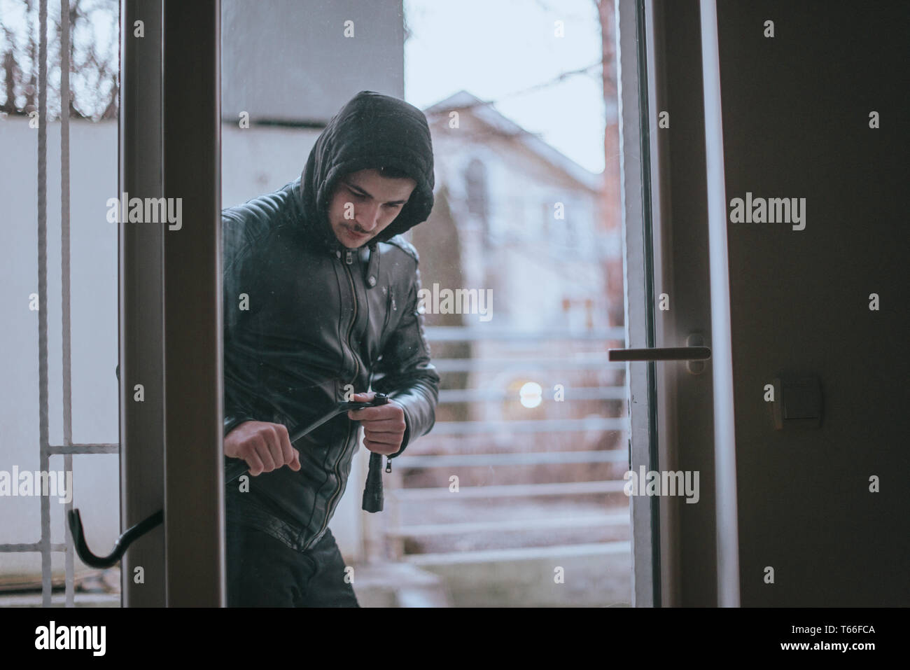 Burglar entering through window hi-res stock photography and images - Alamy