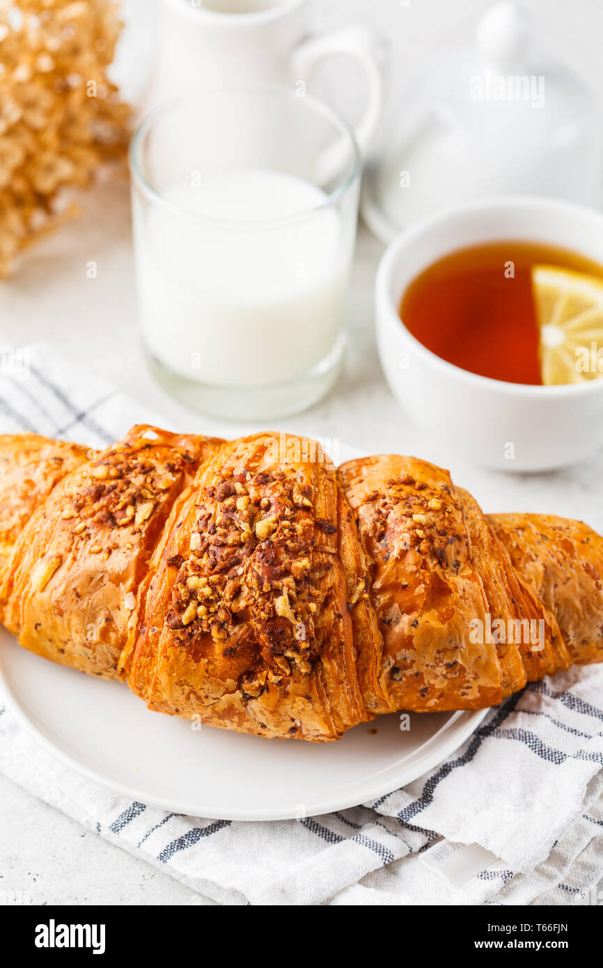 Croissant and tea for breakfast on a white background Stock Photo - Alamy