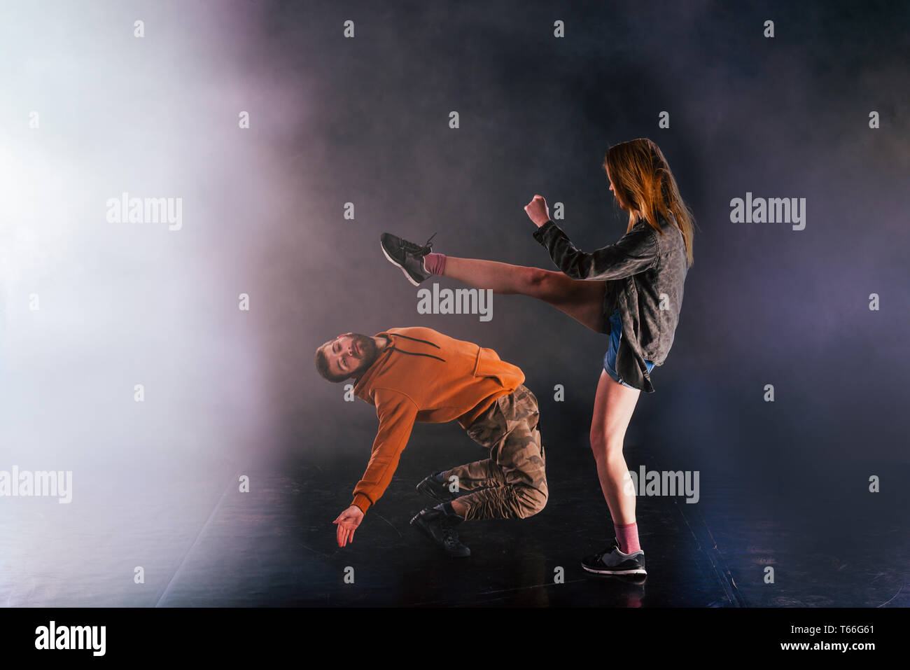 Dance couple shows off their moves the girl is throwing her leg high in ...