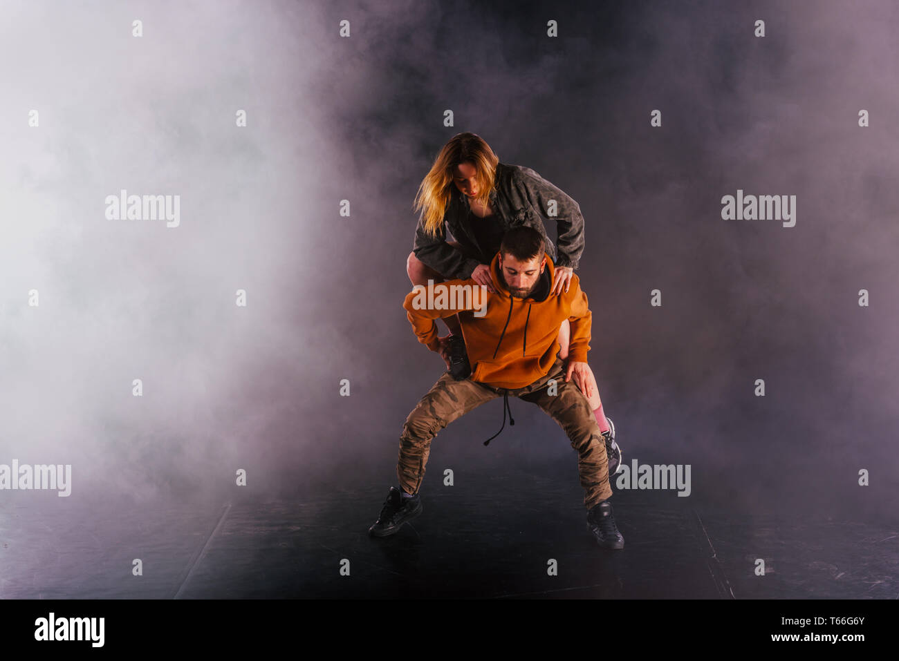 Strong male dancer and an elegant female dancer perform an exotic and ...