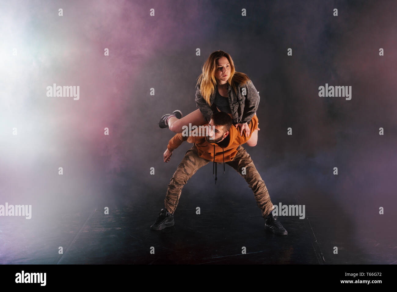 Strong male dancer and an elegant female dancer perform an exotic and ...