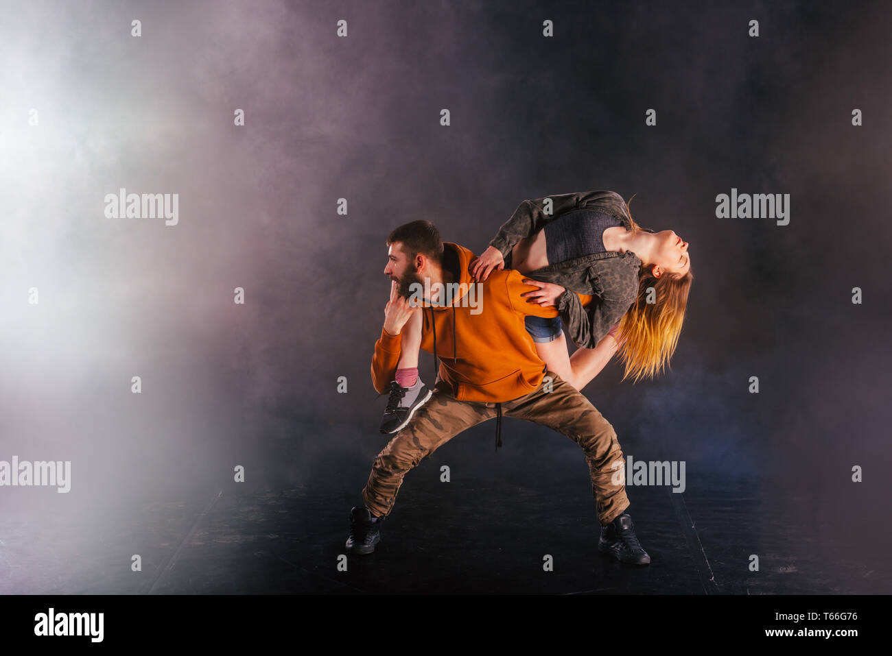 Strong male dancer and an elegant female dancer perform an exotic and ...