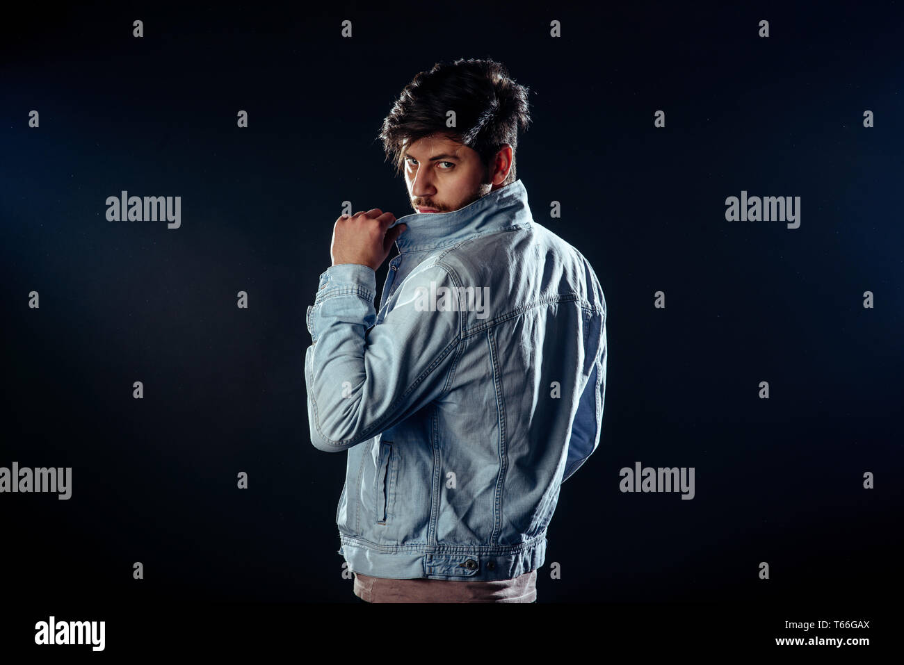 Fashion model man portrait isolated on black background Stock Photo - Alamy