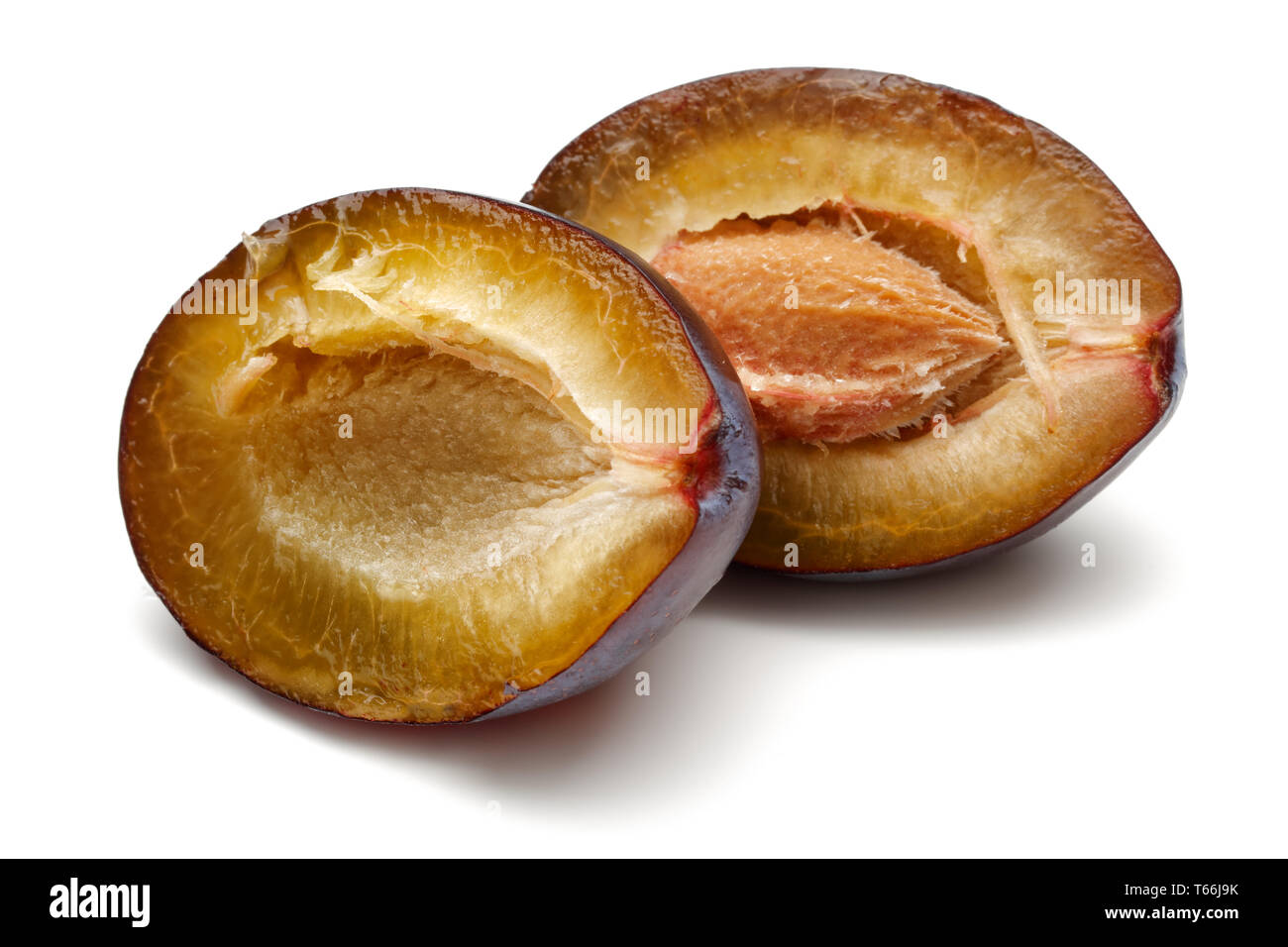 Two half Damson plums isolated on white background Stock Photo - Alamy
