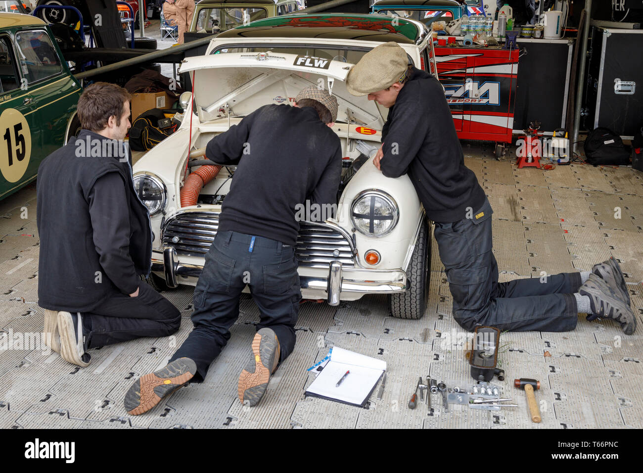 Mechanics at work on the 1963 Morris Mini Cooper S of Darren Turner for ...