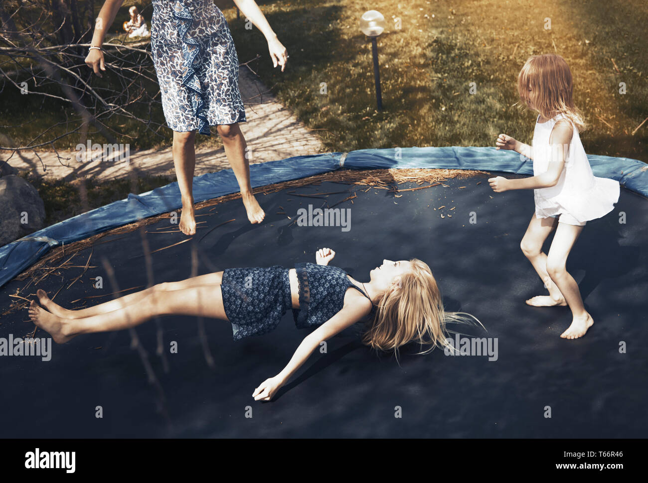 Happy family jumping on trampoline Stock Photo - Alamy