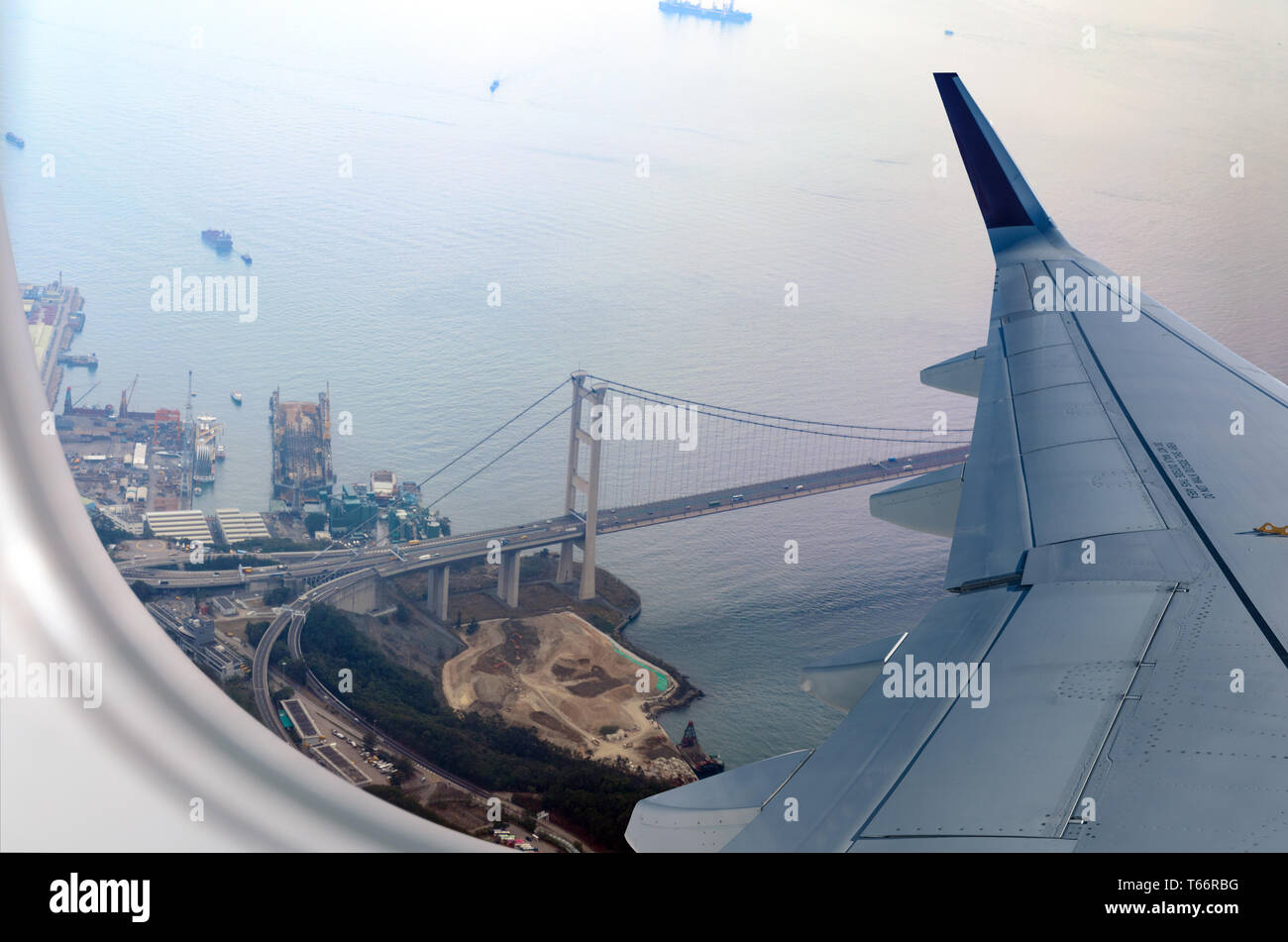 Plane flies over Hong Kong. Window seat on airplane overlooking to Kap ...