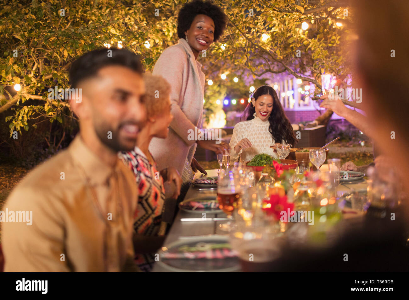 Friends enjoying dinner garden party Stock Photo - Alamy