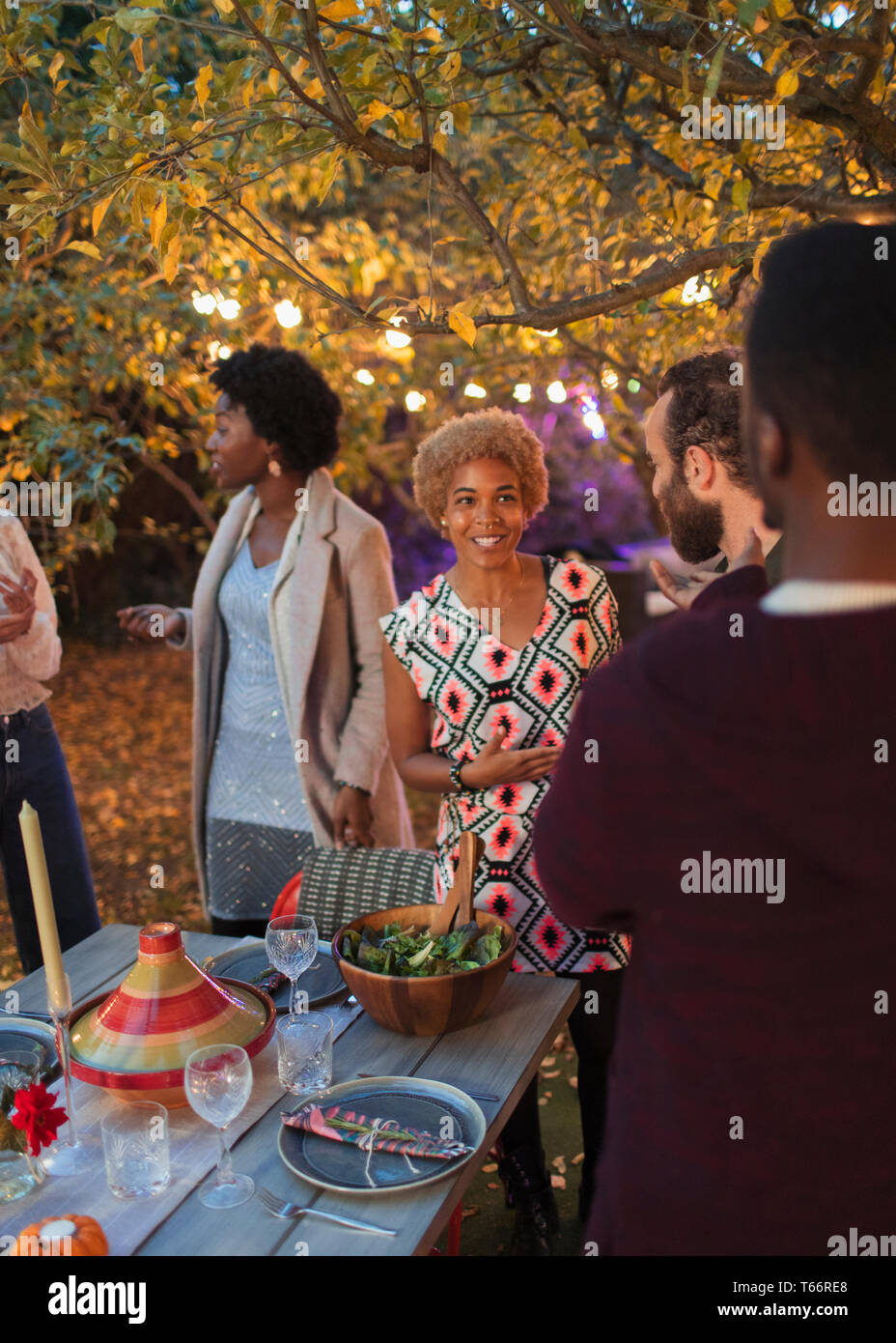 Friends talking at dinner garden party Stock Photo - Alamy