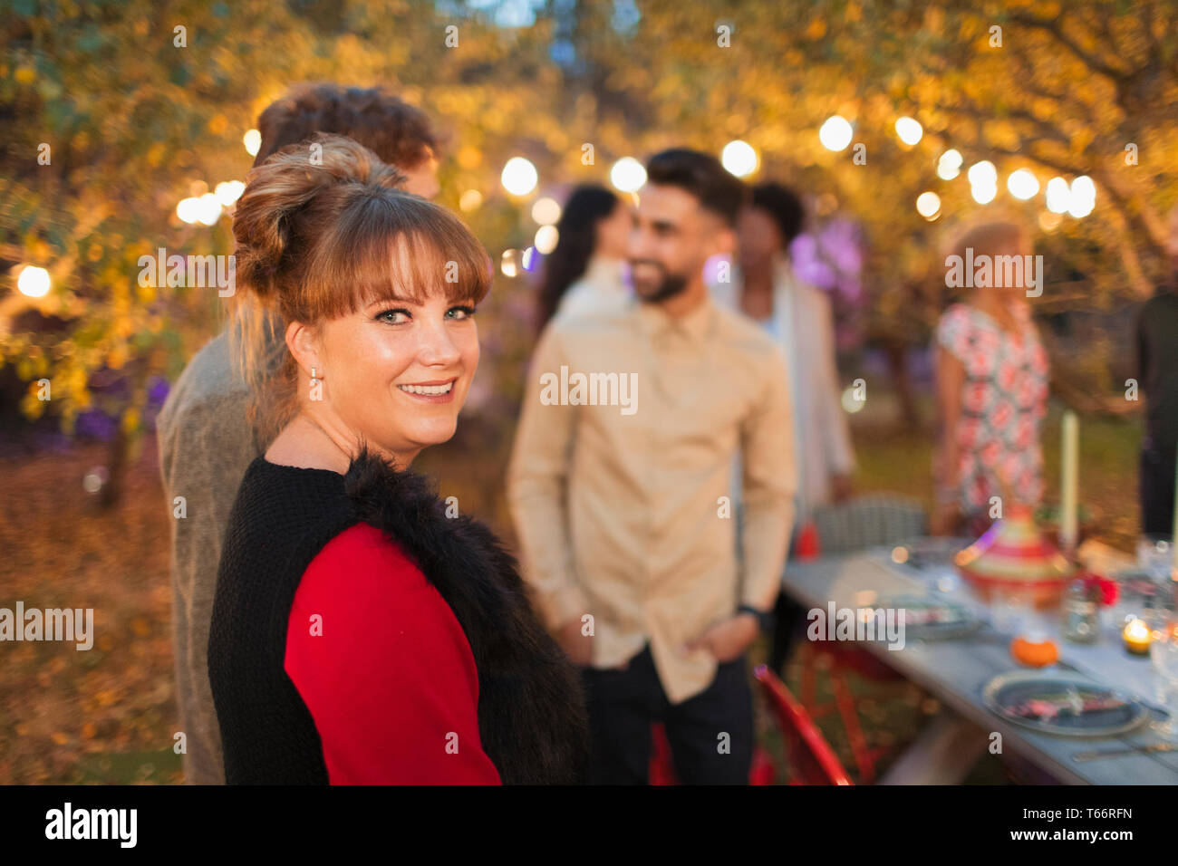 Portrait smiling woman enjoying dinner garden party Stock Photo - Alamy
