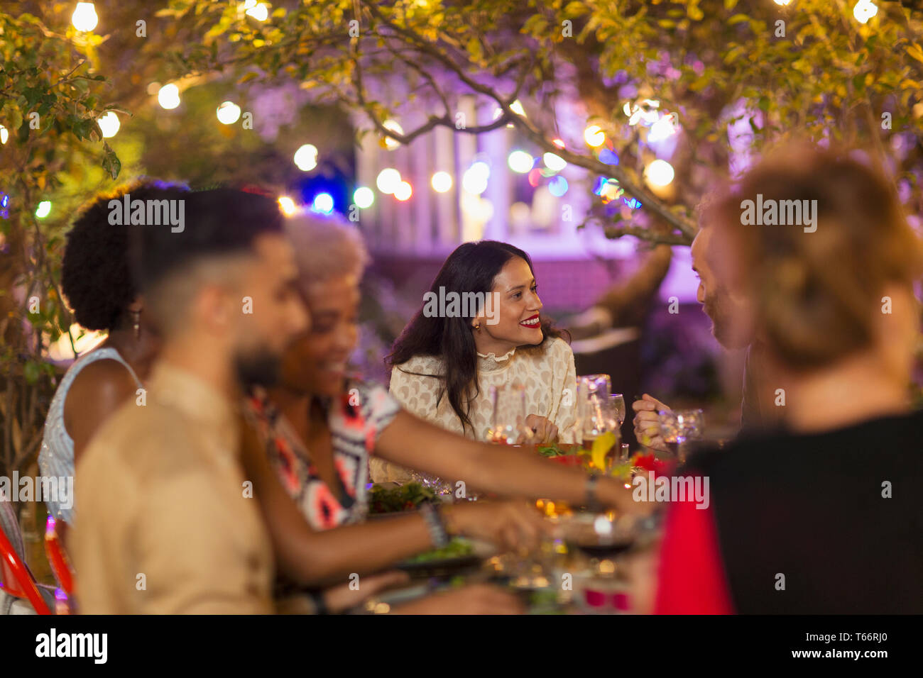 Friends enjoying dinner garden party Stock Photo - Alamy