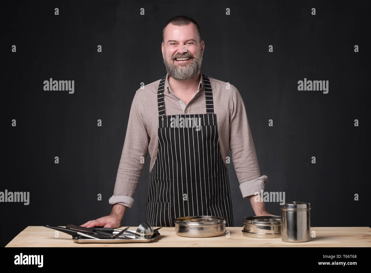 Bearded male chef showing different spices he uses. Secret of delicious ...