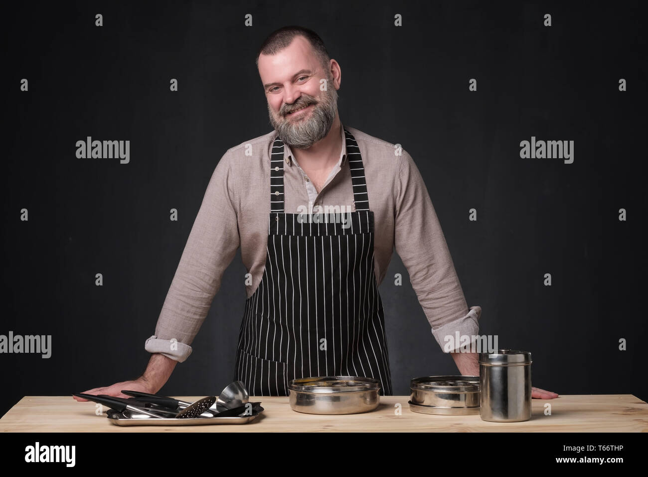 Bearded male chef showing different spices he uses Stock Photo - Alamy