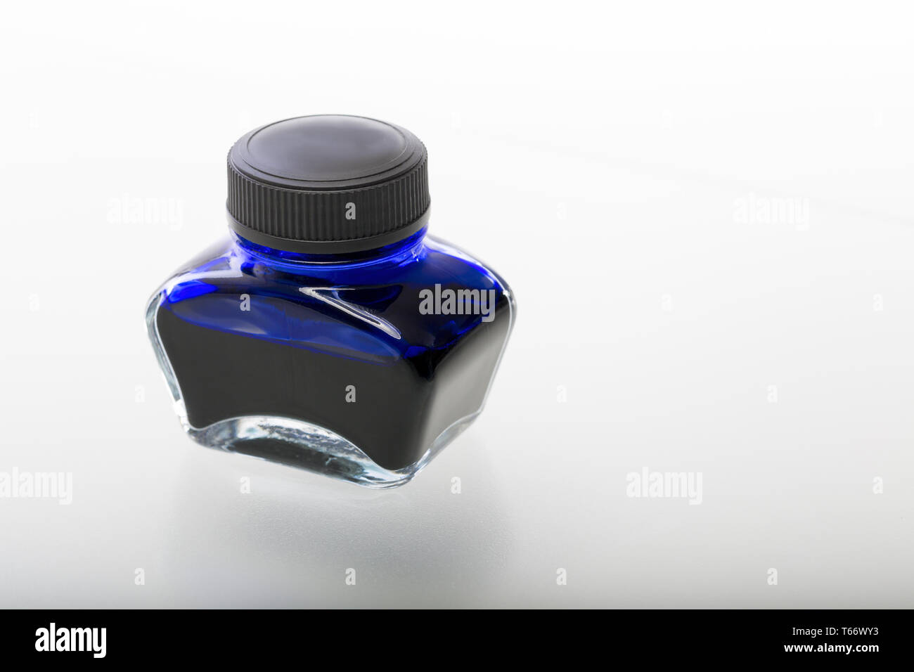 single blue glass ink pot, isolated on white Stock Photo - Alamy