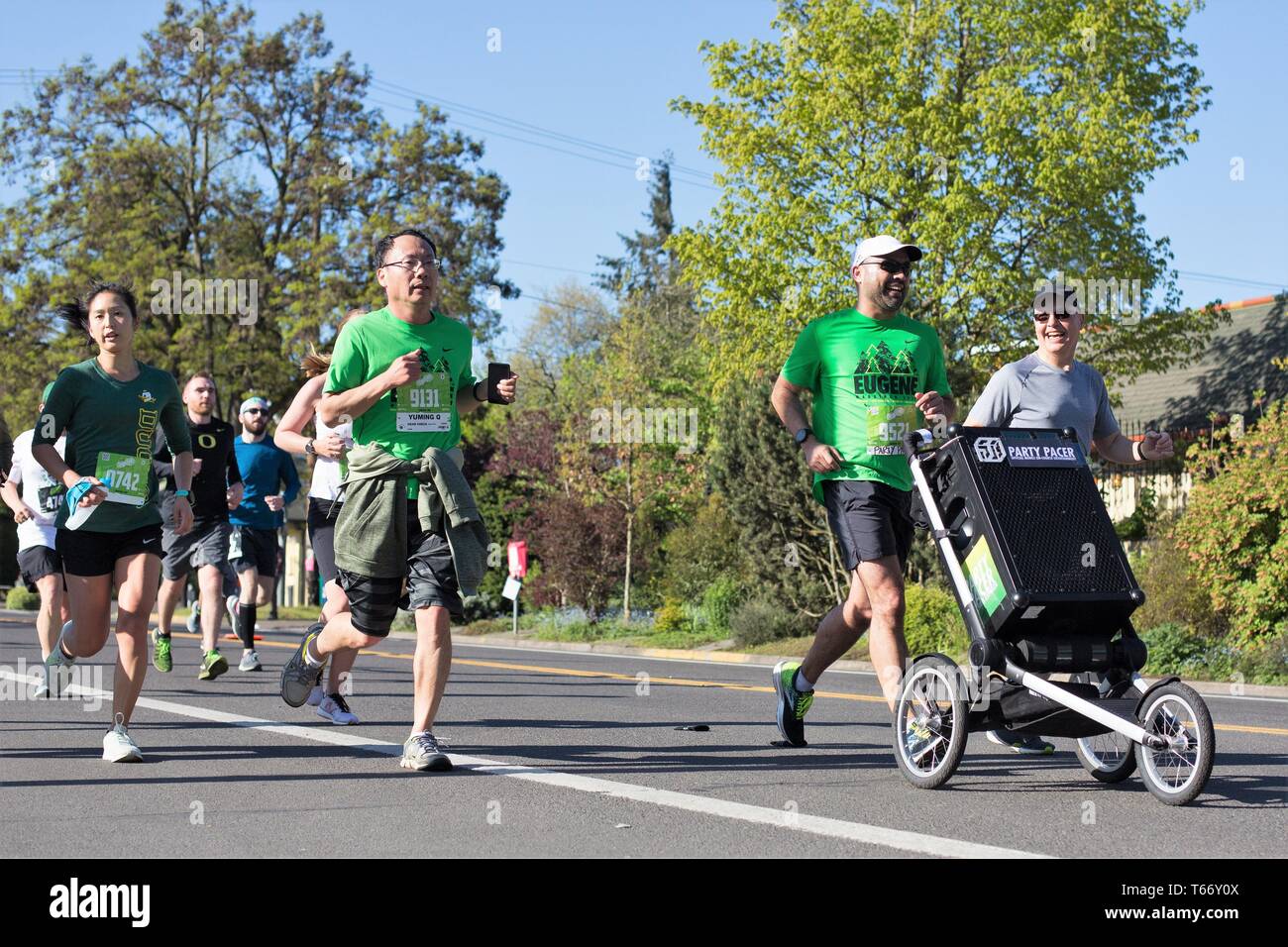 Two runners push a large speaker blaring music as the "party pacer ...