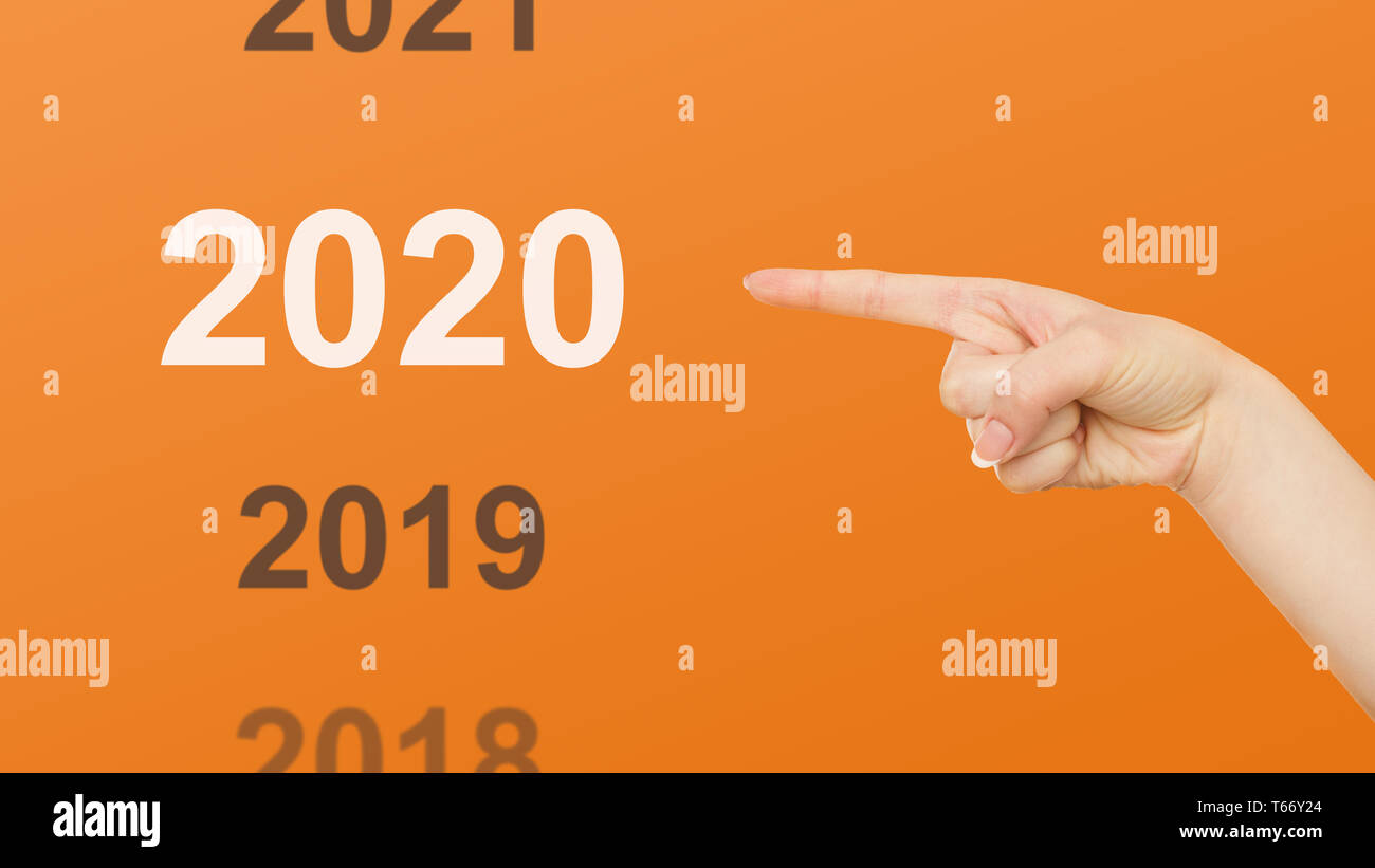 Hand pointing year 2020. New 2020 year concept Stock Photo - Alamy