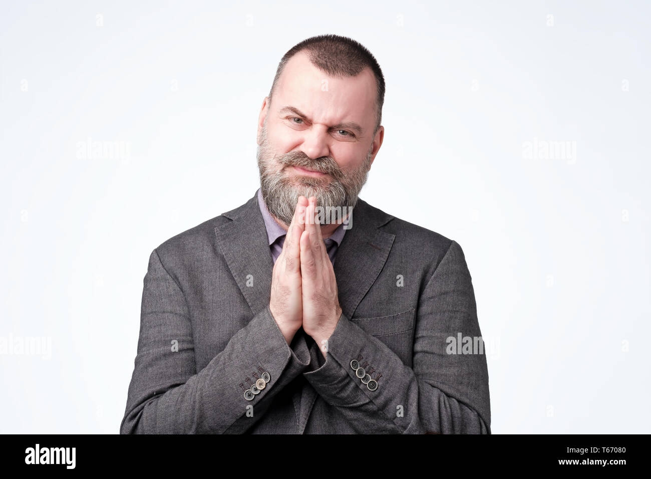 Hopeful man join hands in prayer asking for help Stock Photo - Alamy