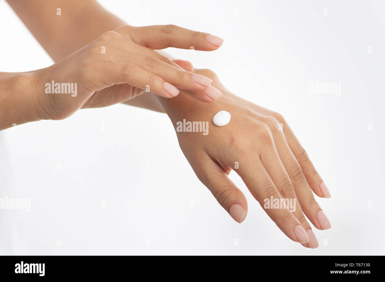 Cosmetics concept. Woman applying hand cream, white background, closeup ...