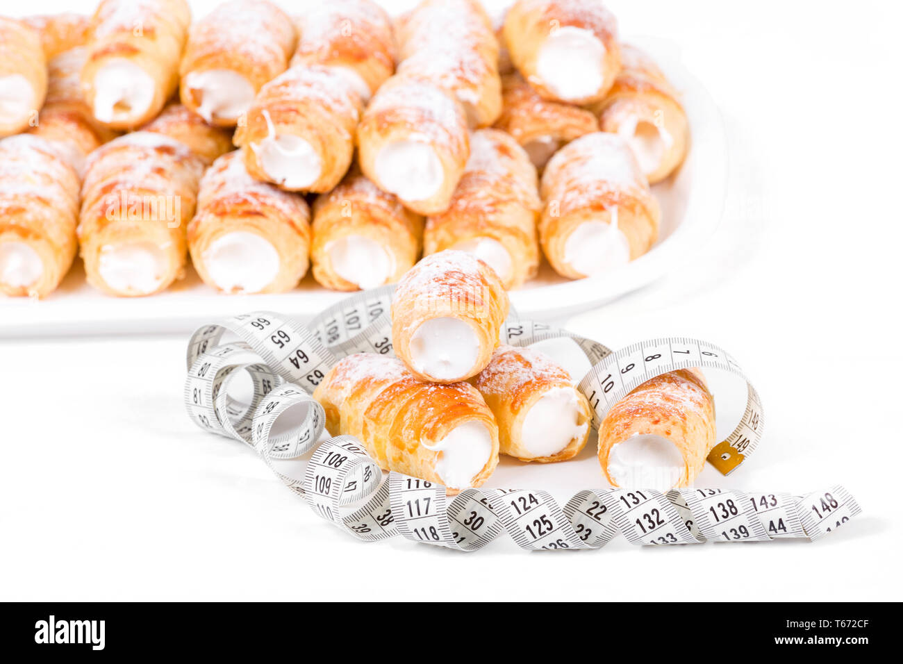 concept of slimming, cakes with measuring tape Stock Photo - Alamy