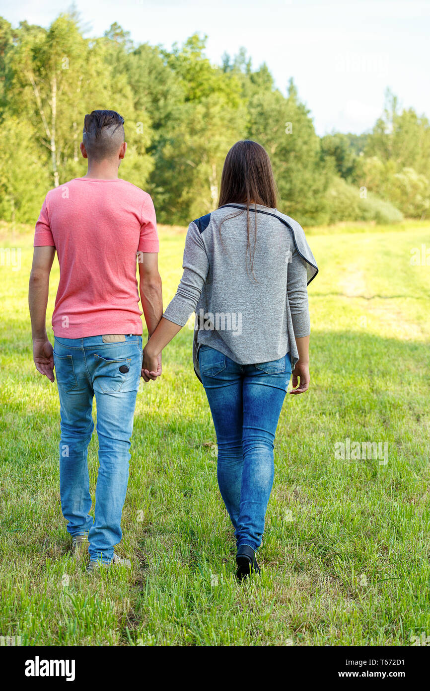 Rear view of young couple walking outdoor Stock Photo - Alamy
